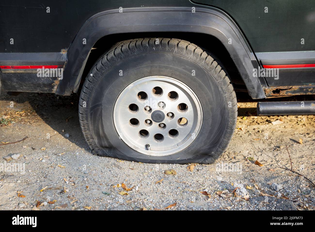Flat tire of a car Stock Photo - Alamy