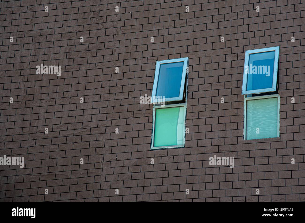 Closed glass windows brick brown wall Stock Photo - Alamy