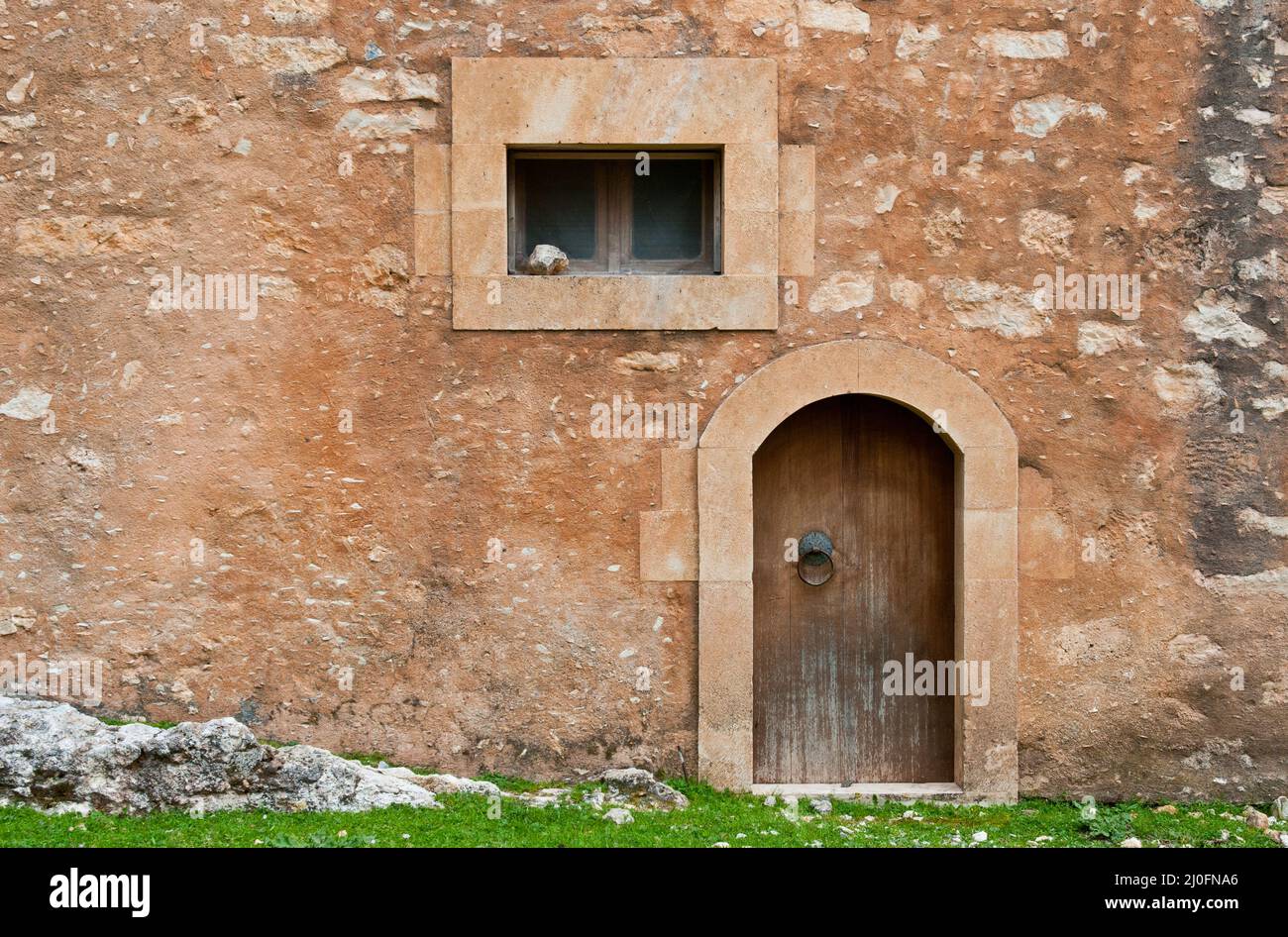Details of a stone wall with window and door Stock Photo - Alamy