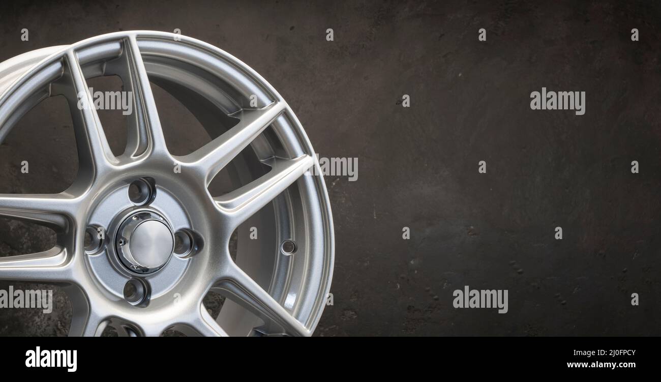 new grey alloy wheels on a dark textured black background. car wheel ...