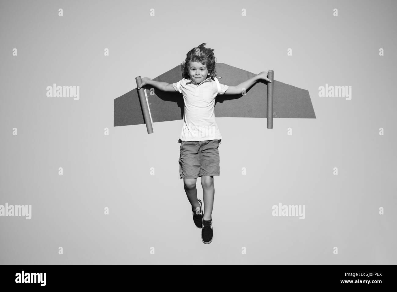 Kids fly. Funny child boy pilot flying with toy cardboard airplane ...