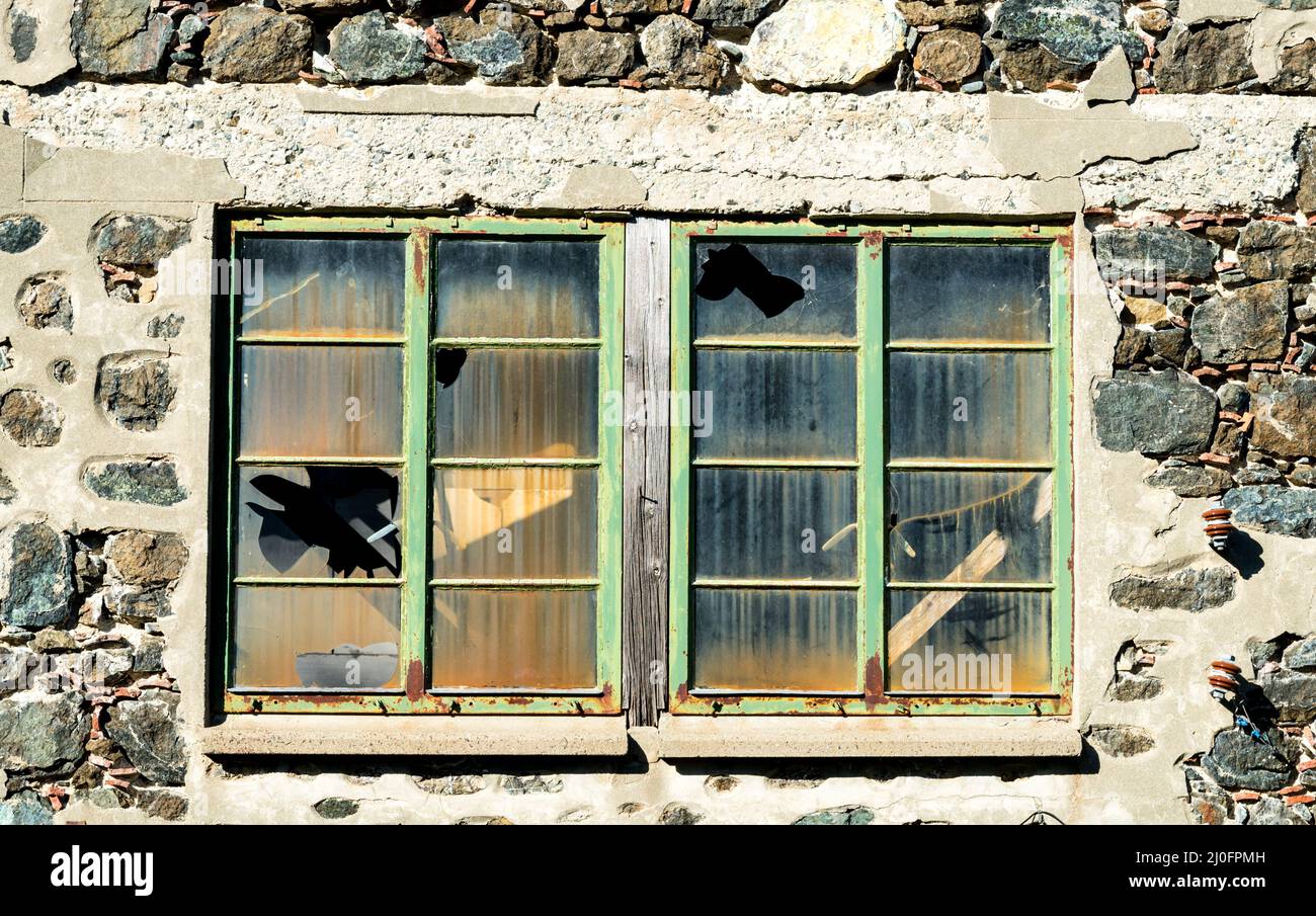 Closed windows with broken glass Stock Photo - Alamy