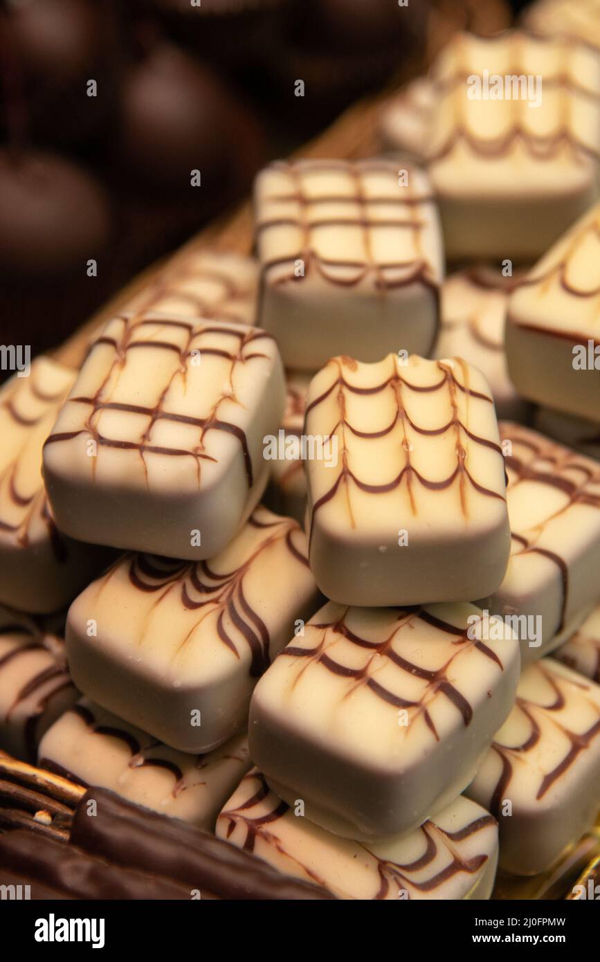 Delicious and tasty sweet bar of white chocolates at a confectionery ...