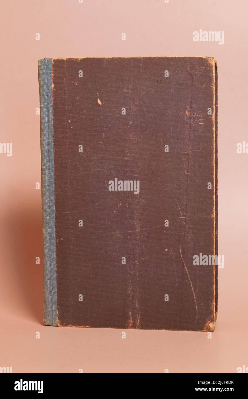 The cover of an old worn book on a colored background Stock Photo - Alamy