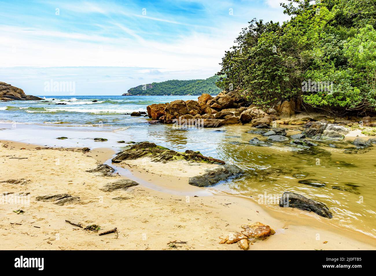 River flowing into the beach between the sea, the rocks and the ...