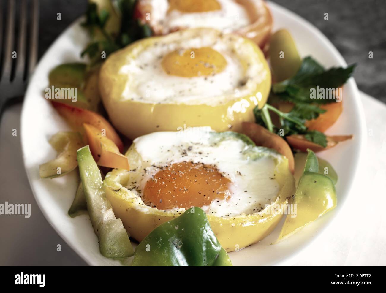 Baked bell pepper with egg inside the pepper Stock Photo - Alamy