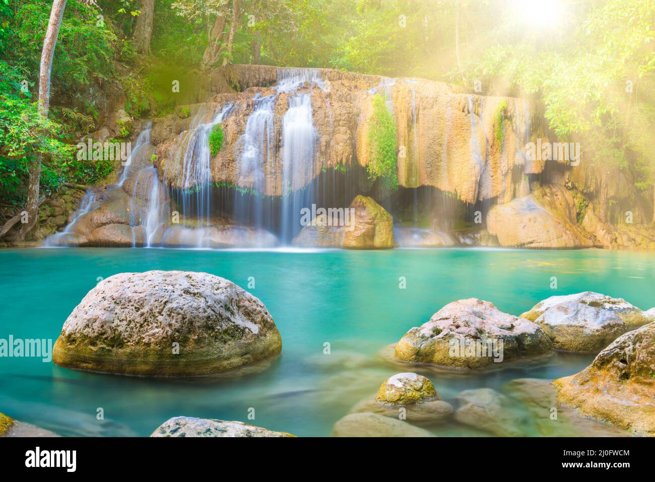 Tropical waterfall with emerald lake and rocks in jungle forest Stock ...