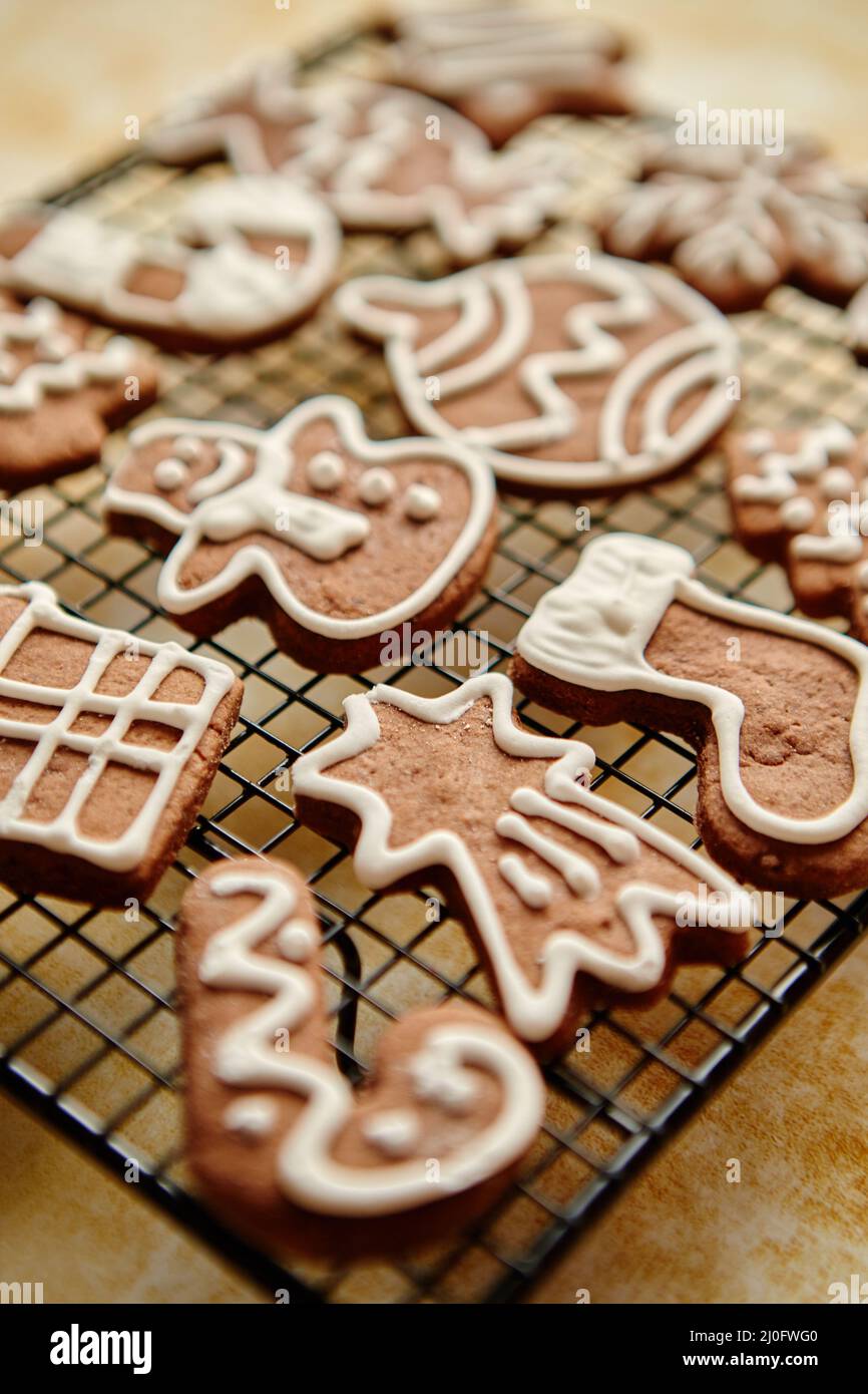 Fresh baked Christmas shaped gingerbread cookies placed on steel grill ...