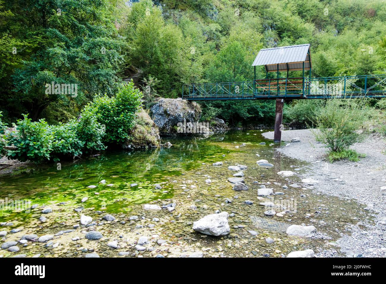 Wooden cottage in the bridge over a river Stock Photo - Alamy