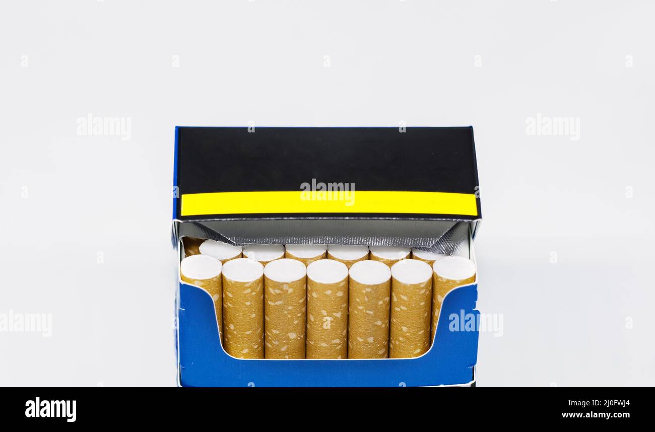 Group of cigarettes inside an open blue packet isolated on a white ...