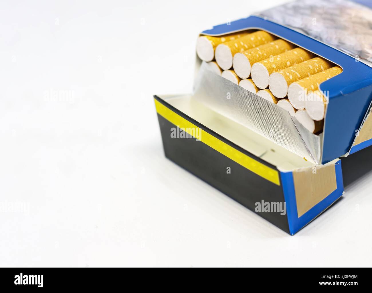 Group of cigarettes inside an open blue packet isolated on a white ...