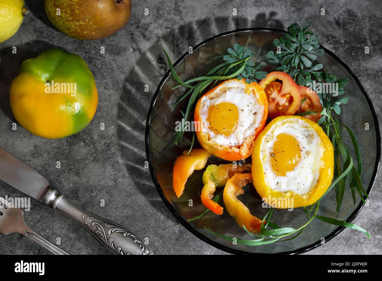 Baked bell pepper with egg inside the pepper Stock Photo - Alamy