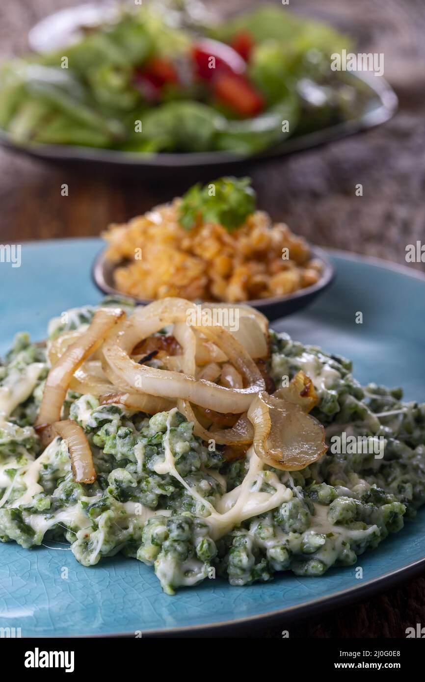 Bavarian spinach spaetzle with onions on the plate Stock Photo - Alamy