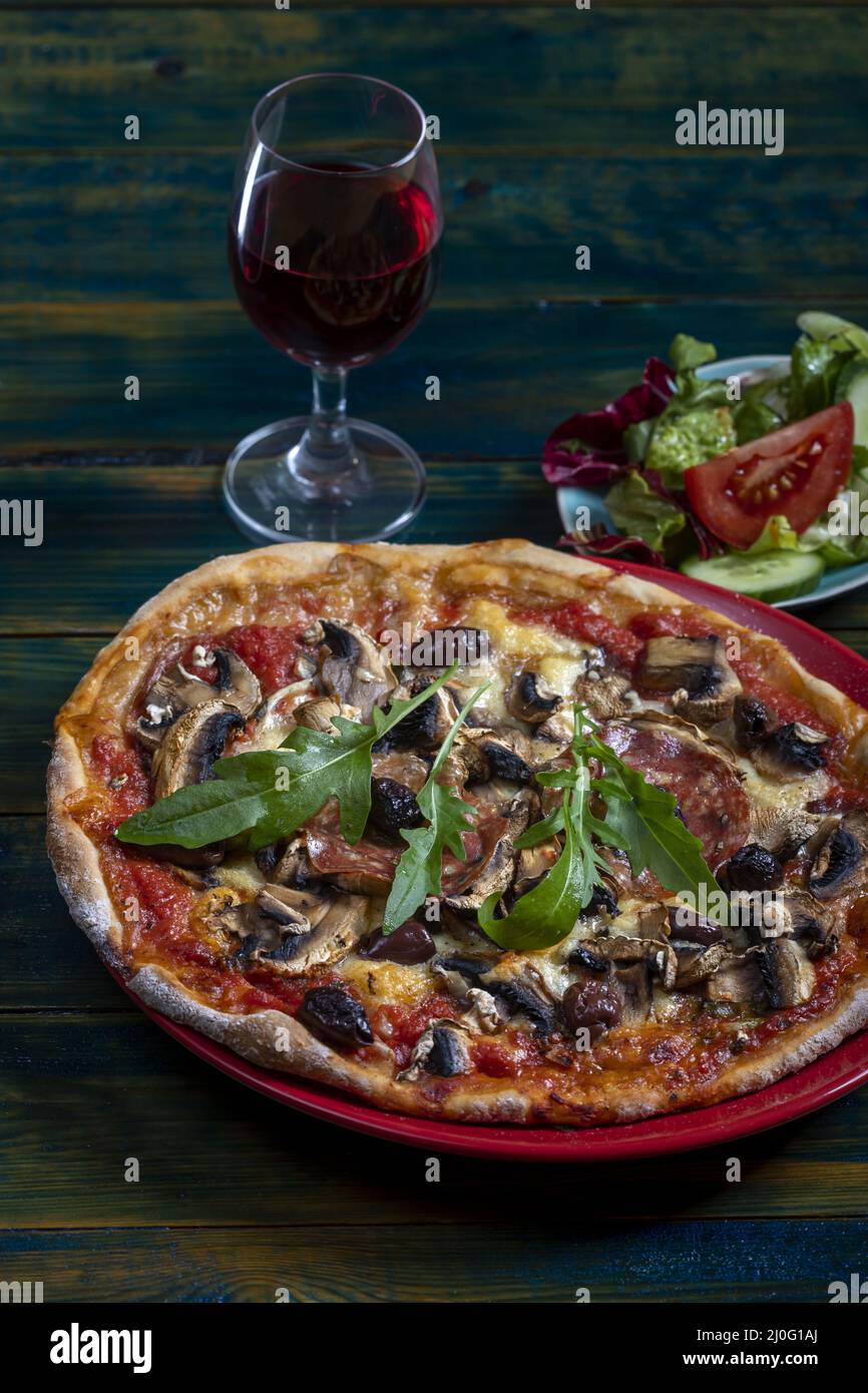 Overview of a pizza with salad Stock Photo - Alamy