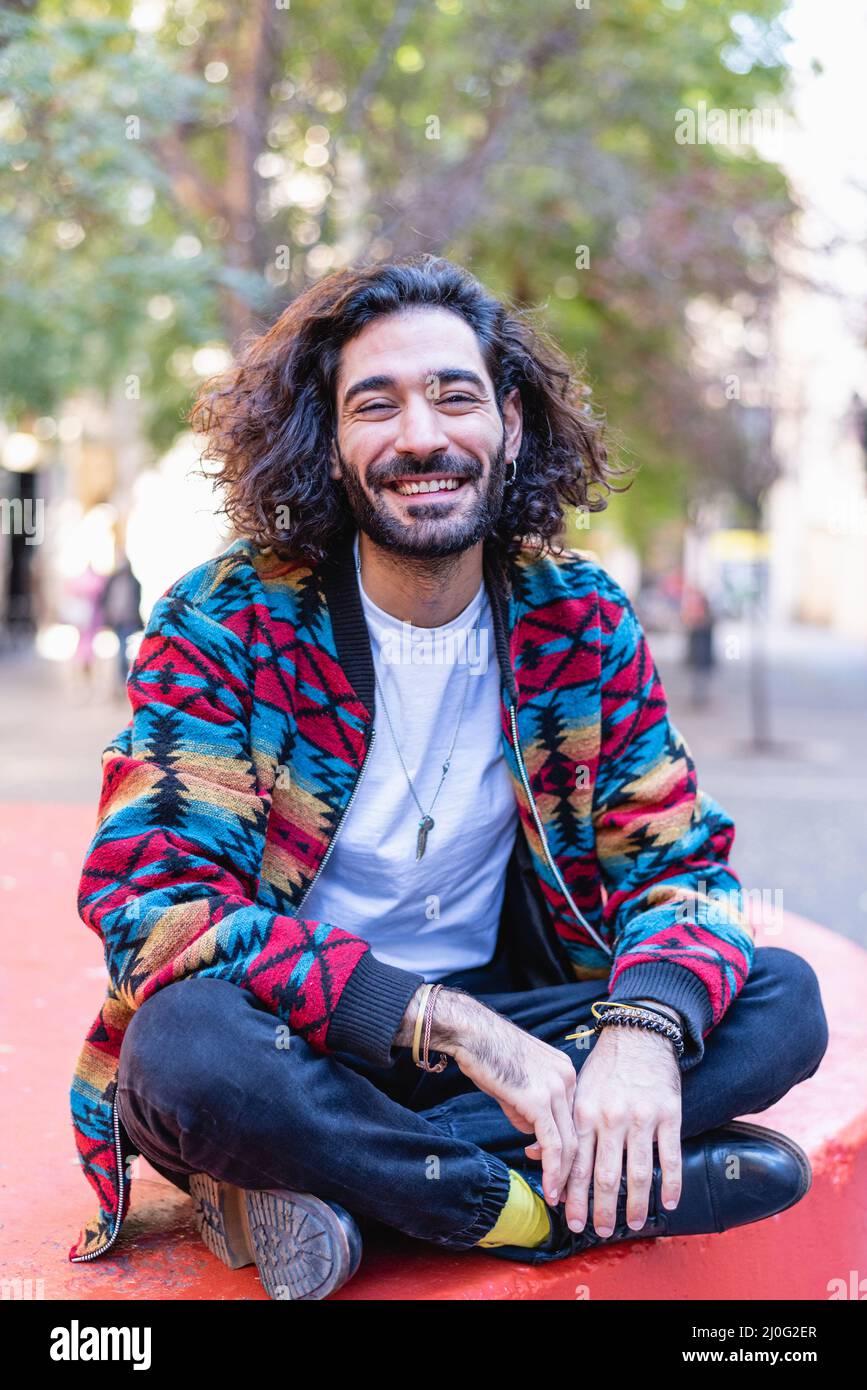 Optimistic Hispanic male in stylish clothes with beard and dark hair ...