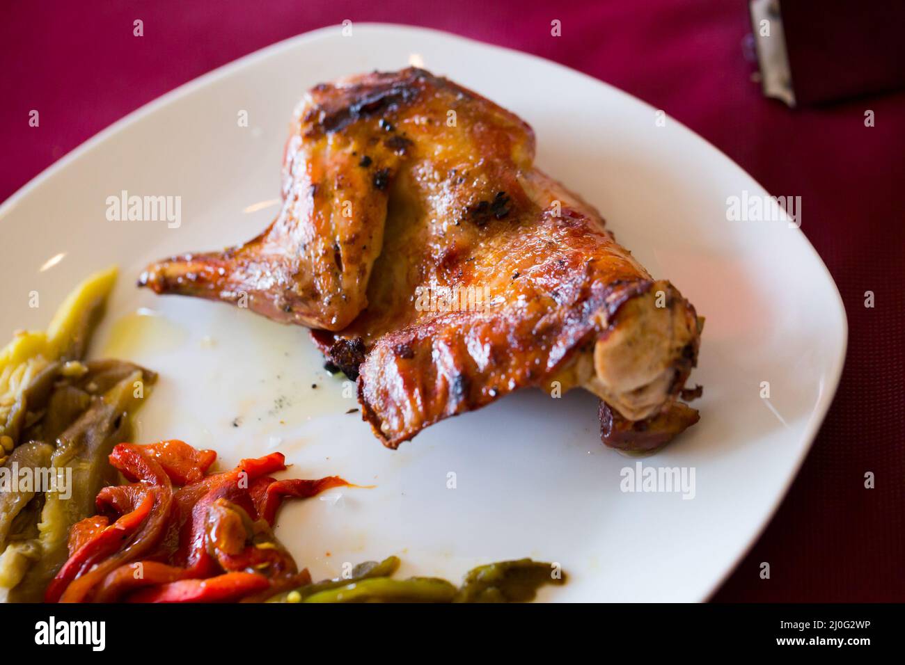 Fried rabbit, served with vegetables at plate, dish of spanish cuisine ...