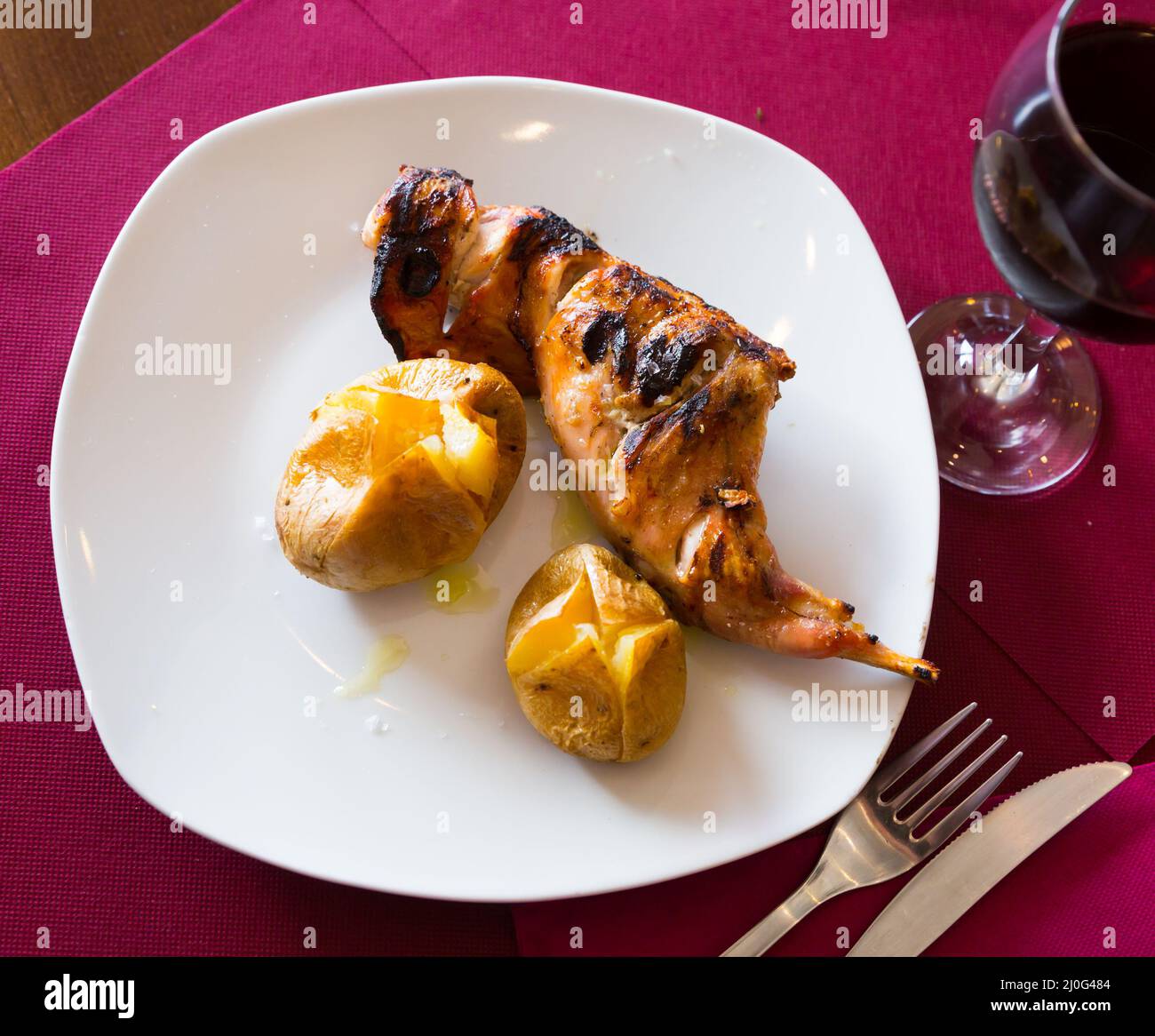 Baked in oven quarter of rabbit, served with pototoes at plate Stock ...