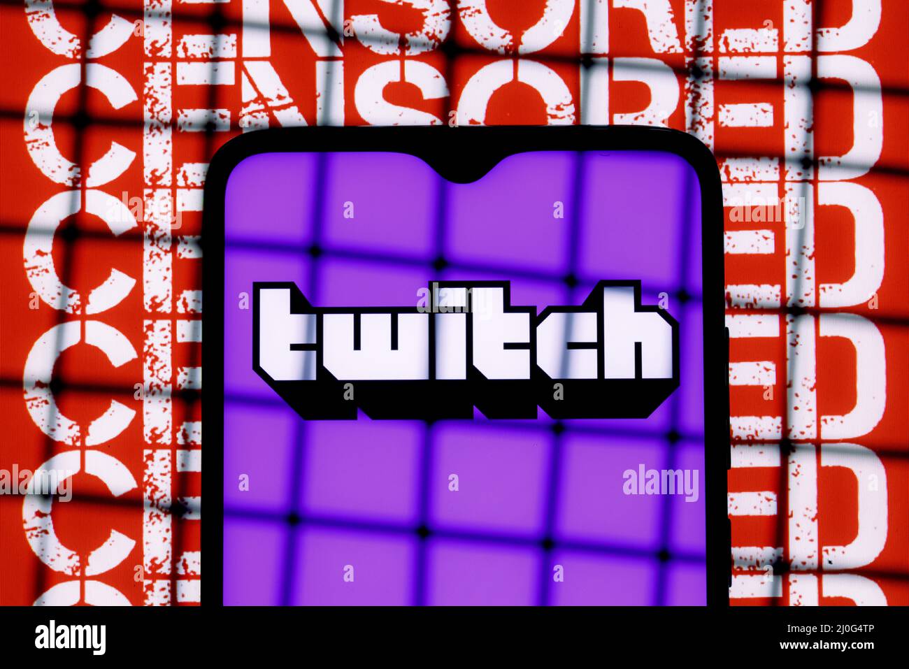 Twitch live streaming service logo on the smartphone screen behind the ...
