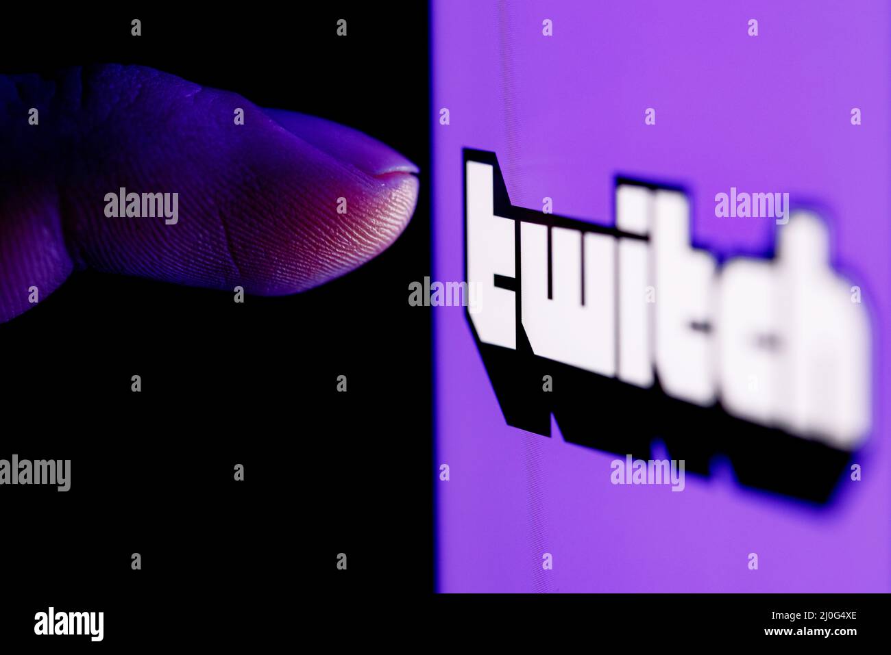 The finger reaches for the Twitch live streaming service logo on the ...