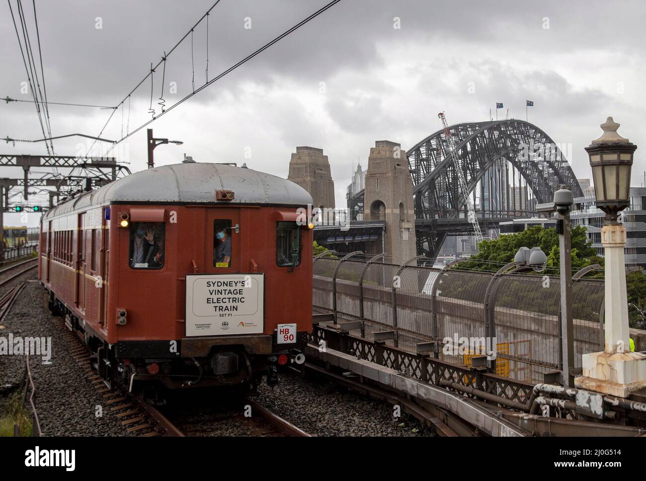 Sydney. 19th Mar, 2022. A vintage train passes Harbour Bridge in Sydney ...