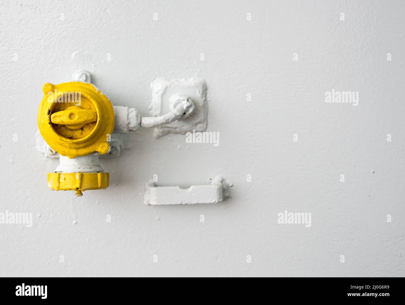 Yellow control industrial switch on a white metallic surface Stock ...