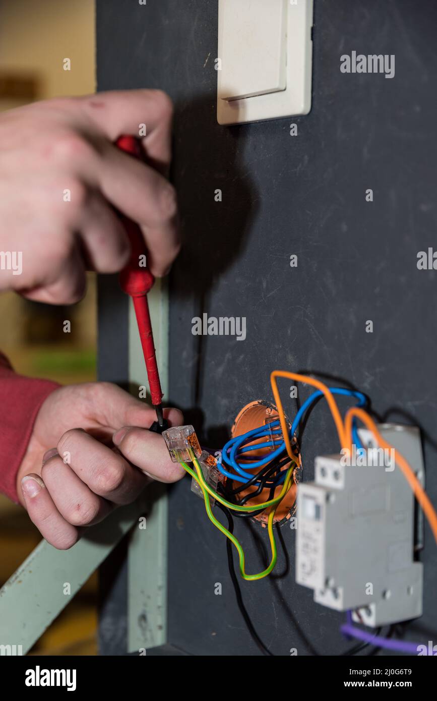 Electrical engineer during installation work - close-up craft Stock ...