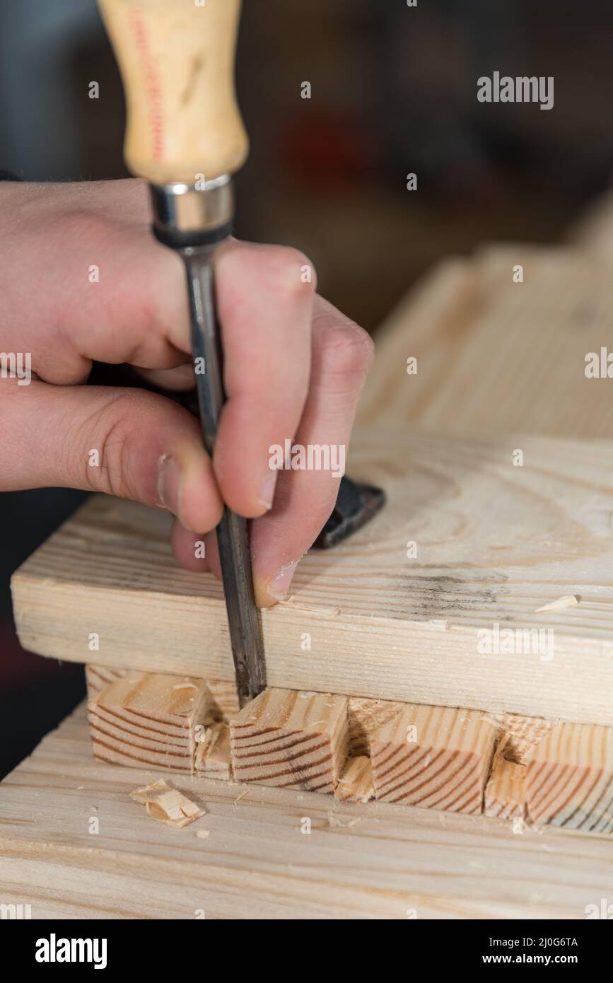 Craftsman works wood with chisels - close-up carpenter Stock Photo - Alamy