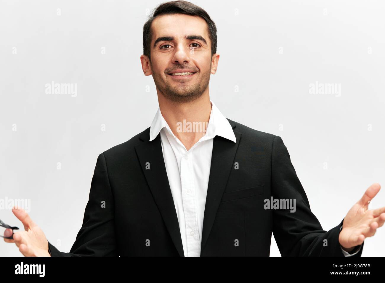 smiling friendly business man raising his hands gas mask in black suit ...