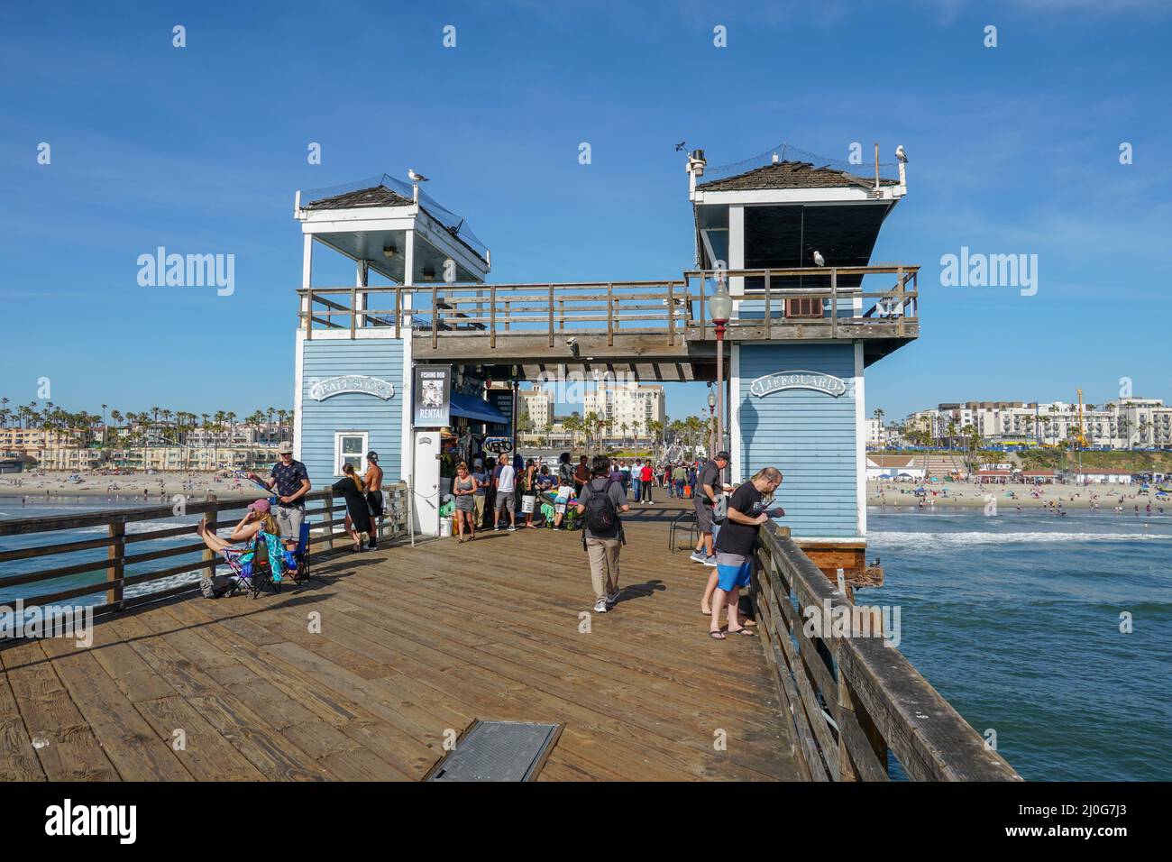 Tourist walking on the Oceanside Pier during blue summer day, Oceanside ...