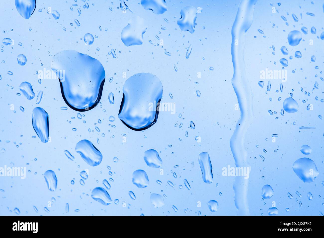 Digital illustration of blue rain drops on a window Stock Photo - Alamy