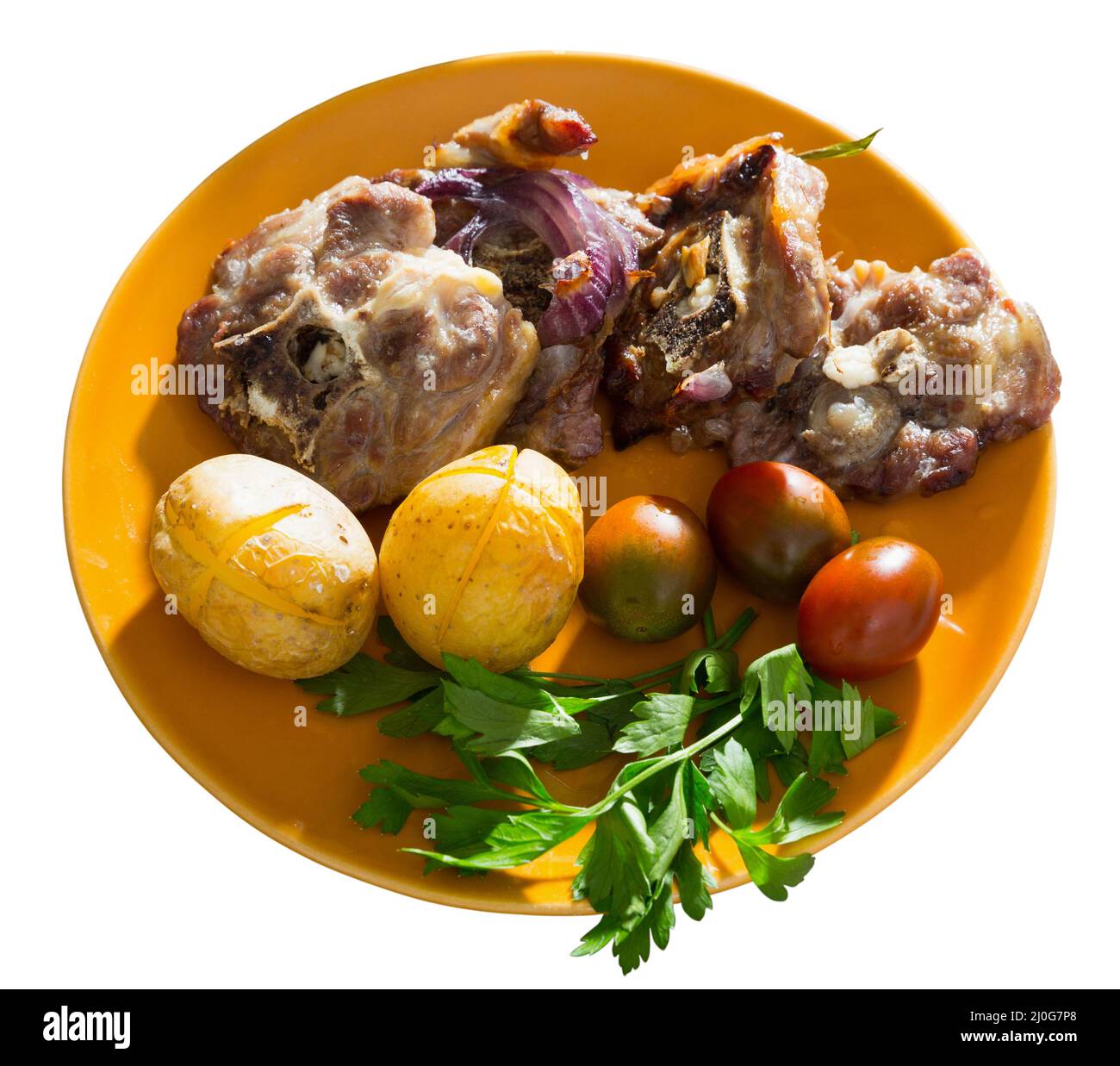 Lamb leg chops with baked potatoes, tomatoes and greens Stock Photo - Alamy