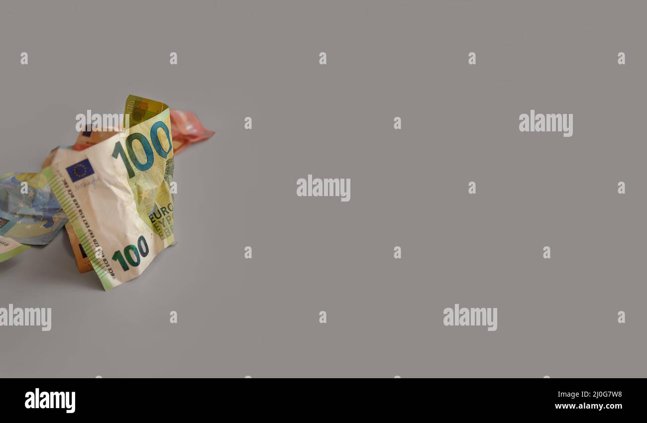 A pile of crumpled euro banknotes on a gray background. Minimalism ...