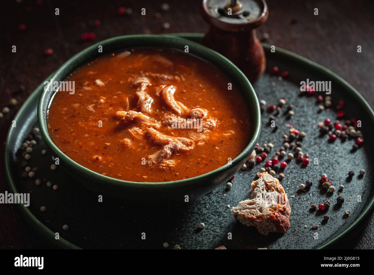 Spicy and aromatic tripe soup served with bread and pepper. Spicy and ...