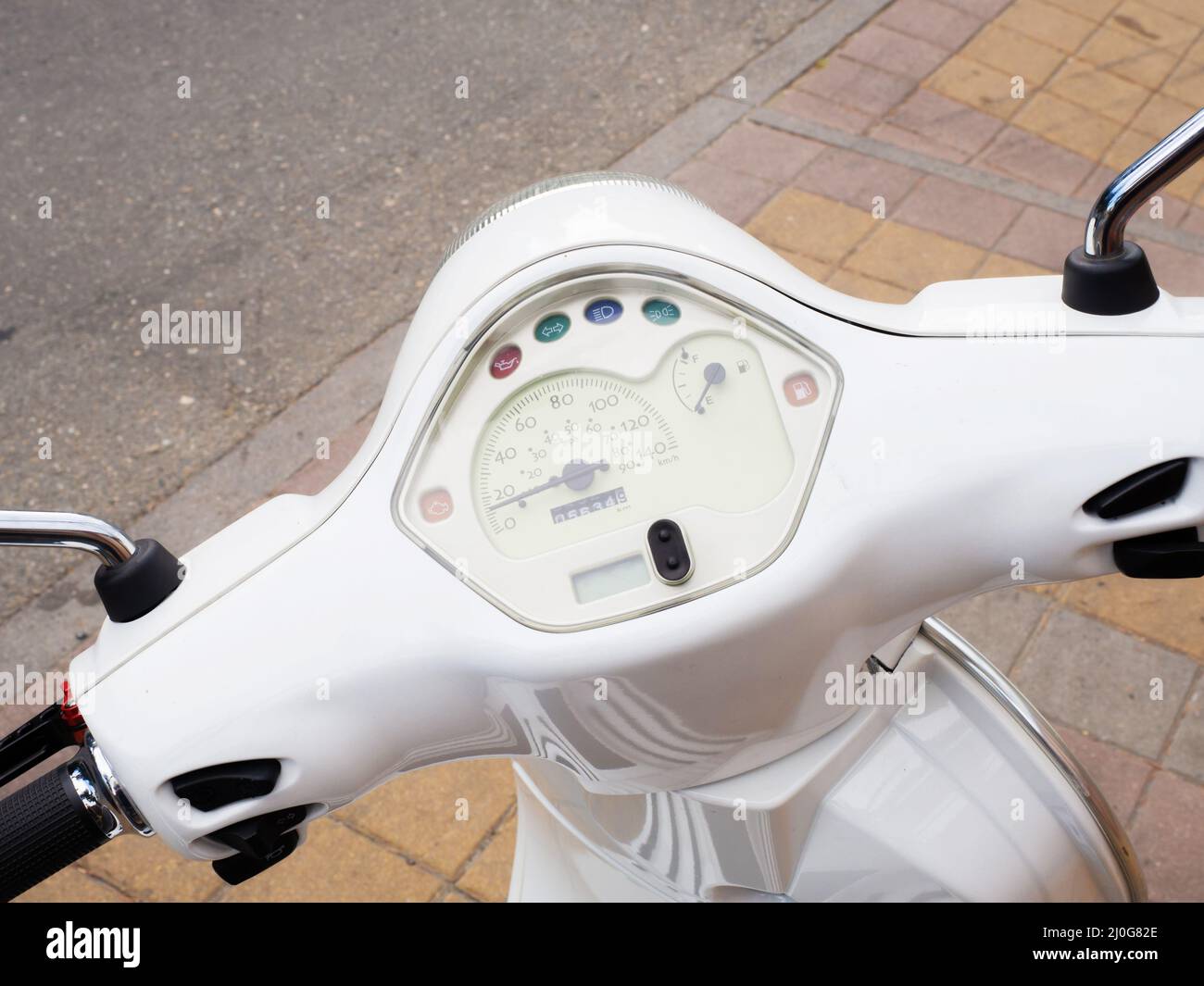 Speedometer on the handlebars of a white motorcycle. Closeup photo ...