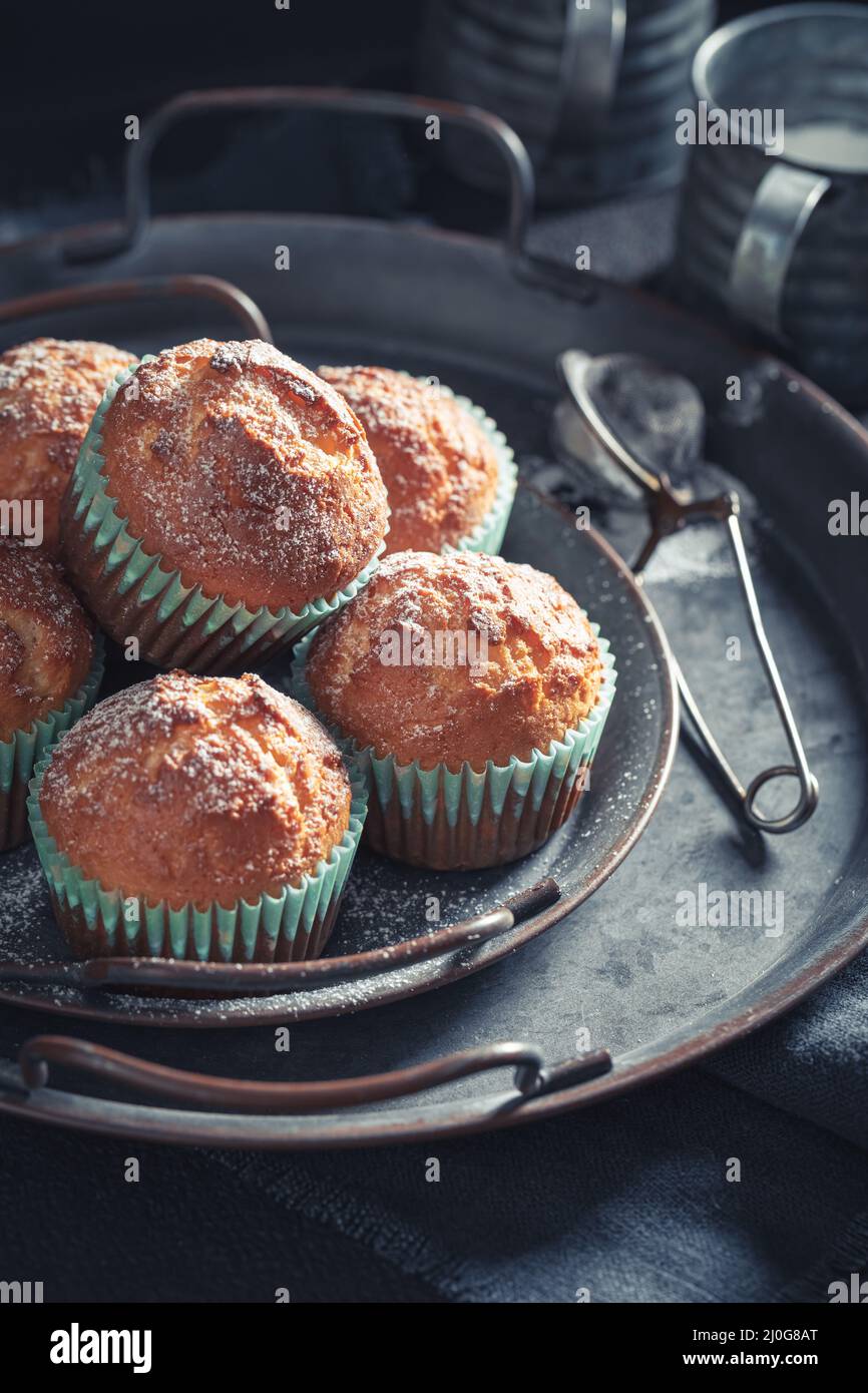 Sweet and tasty yoghurt cupcake on rustic table. Homemade golden ...