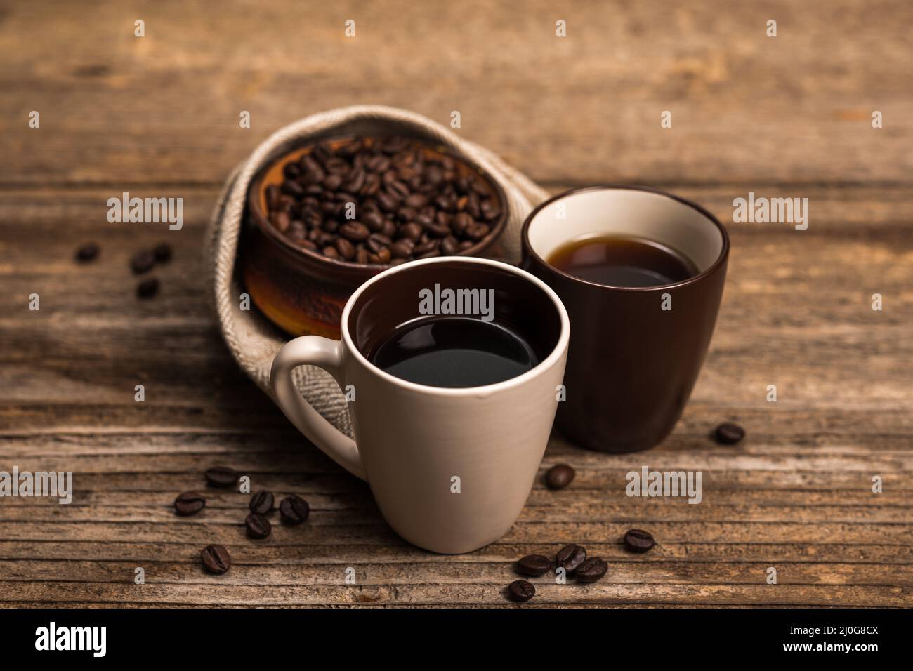 Coffee and coffee beans on old rustic wood table Stock Photo - Alamy