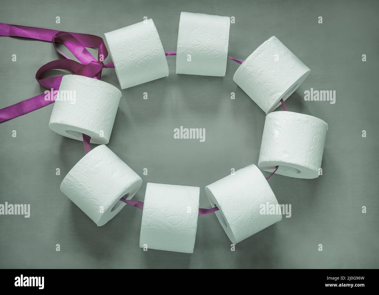Toilet paper rolls connected by a ribbon in a bundle Stock Photo - Alamy