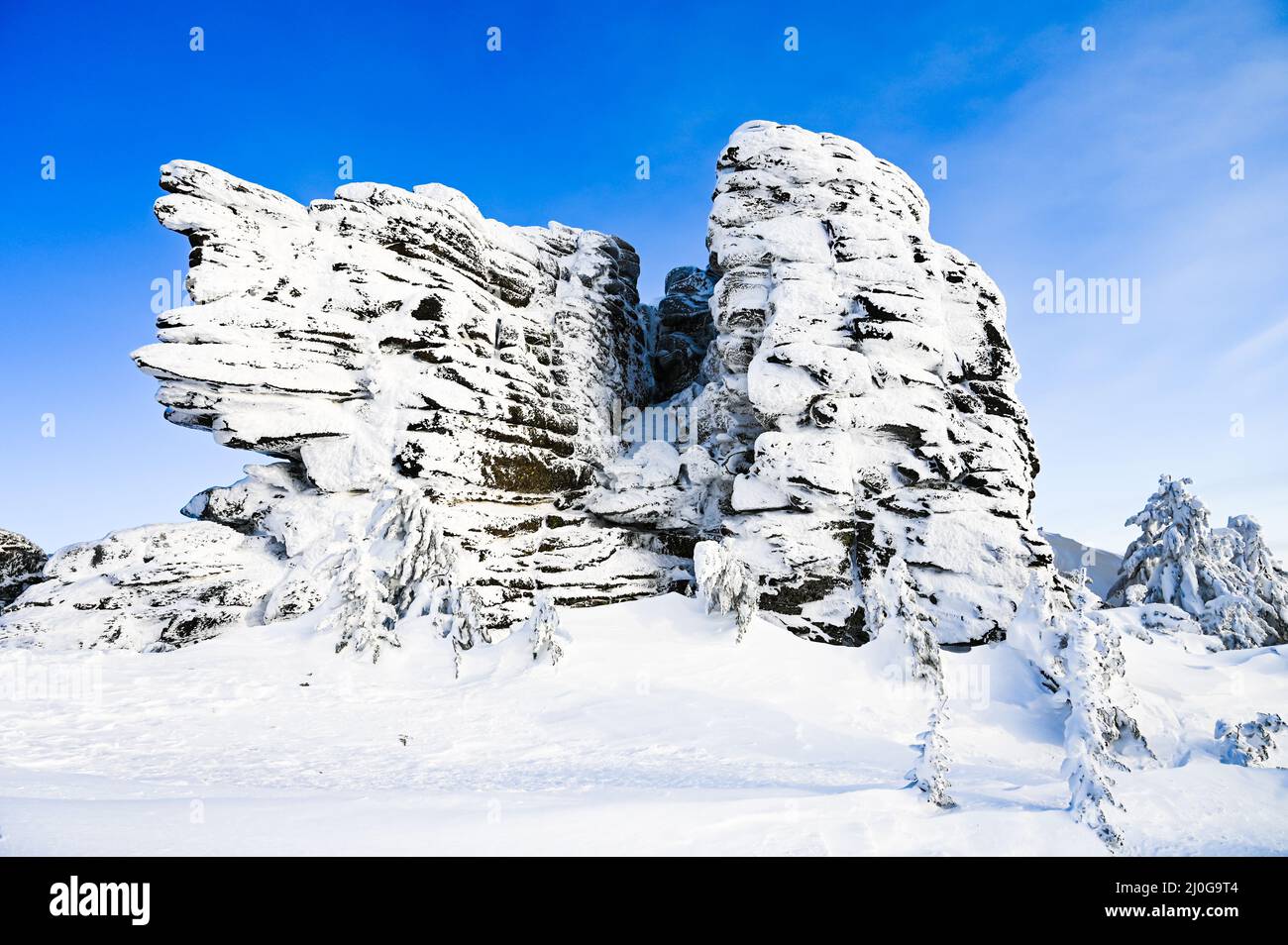 The rock is covered with snow in winter Stock Photo - Alamy