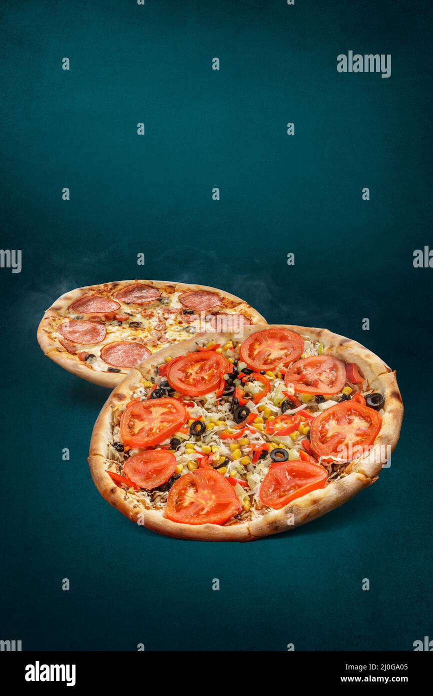 Floating, smoking pizzas on a turquoise background Stock Photo - Alamy