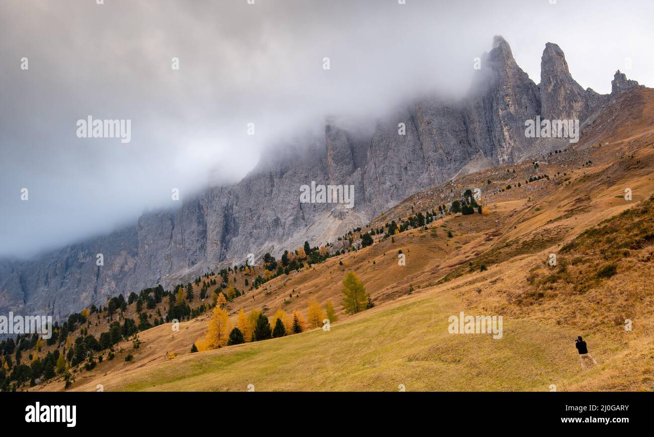 Dolomite mountain peaks covered in fog during sunrise Stock Photo - Alamy