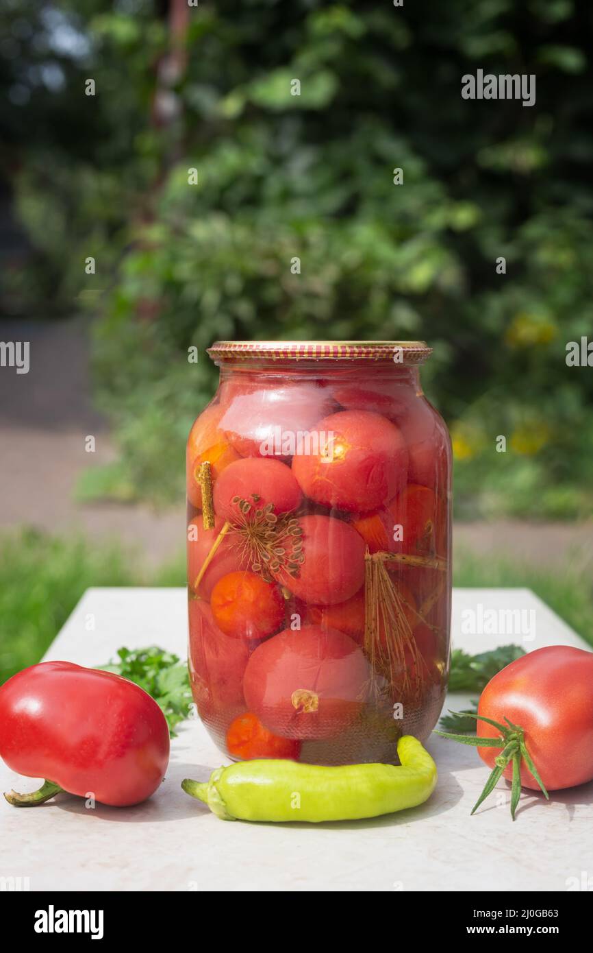 Canned tomatoes in a large glass jar Stock Photo - Alamy