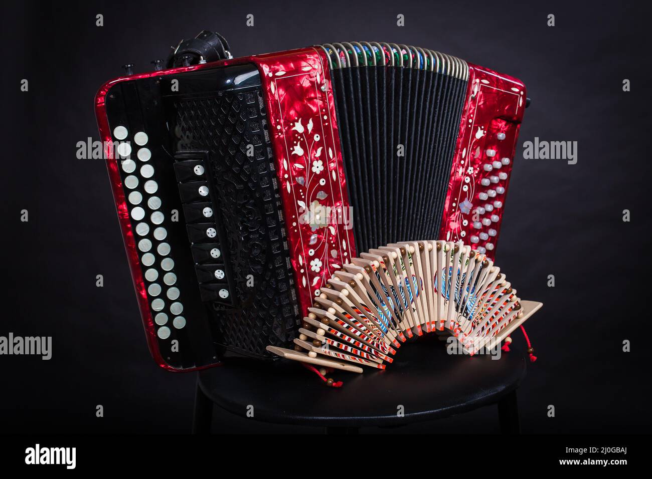 Russian folk instruments.Red bayan on a black background.Russian ...
