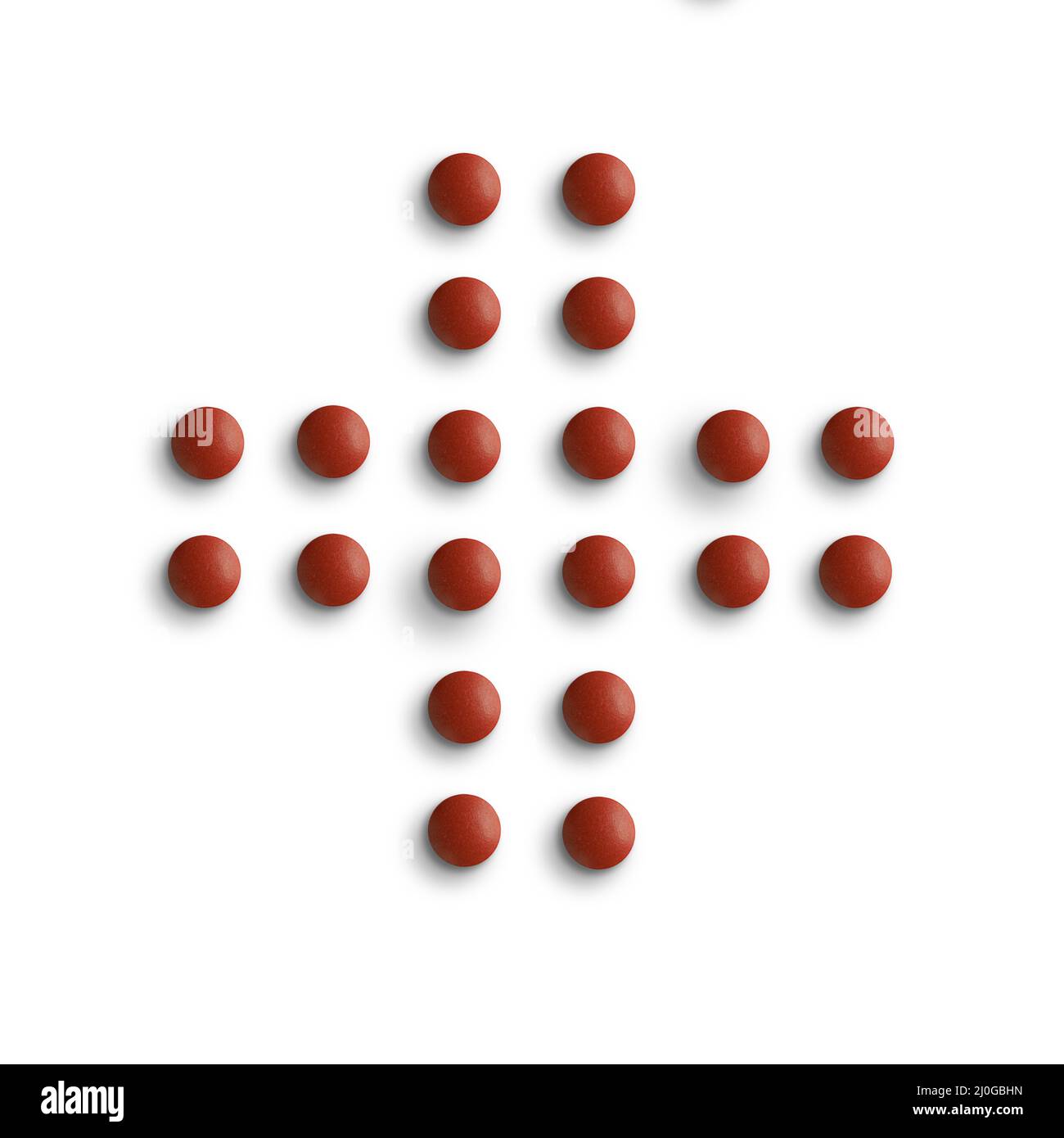 Red cross made from set of red pills isolated on white background ...