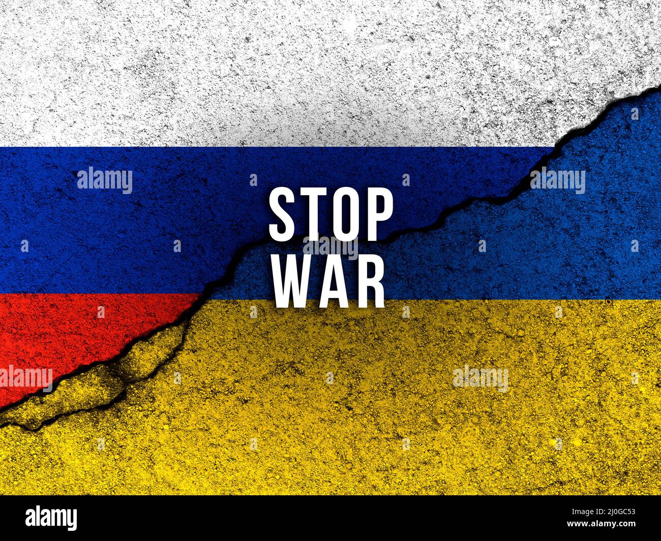 Stop the war text. Russian and Ukraine flags painted on cracked ...