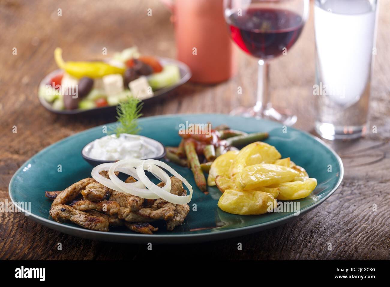 Greek gyros with french fries on wood Stock Photo - Alamy
