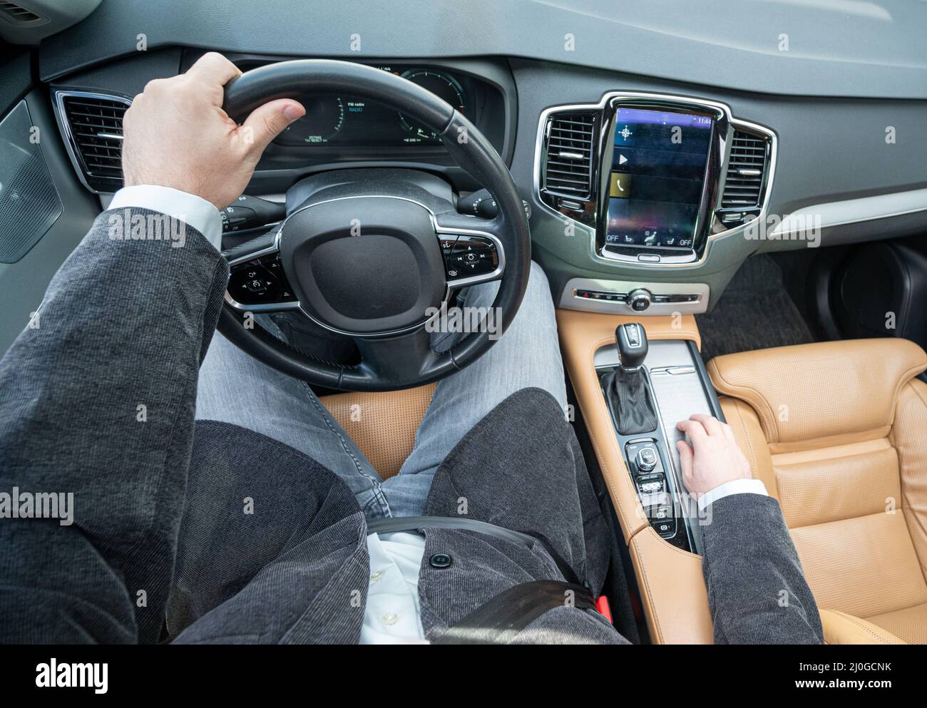 Wide angle of a male driver in luxury car Stock Photo - Alamy