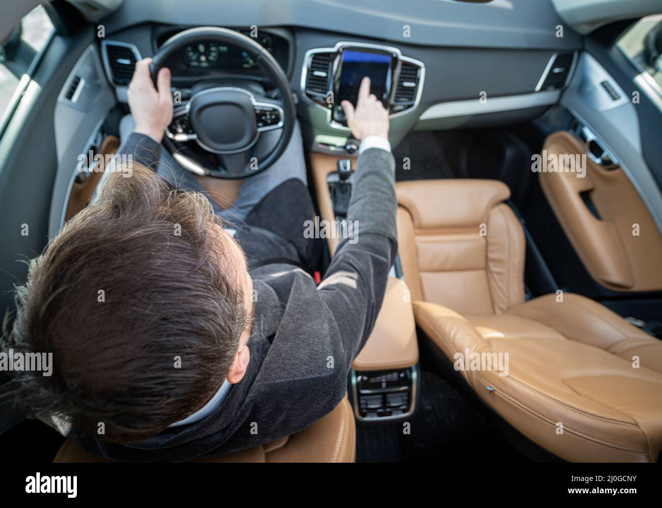 Wide angle of a male driver in luxury car Stock Photo - Alamy