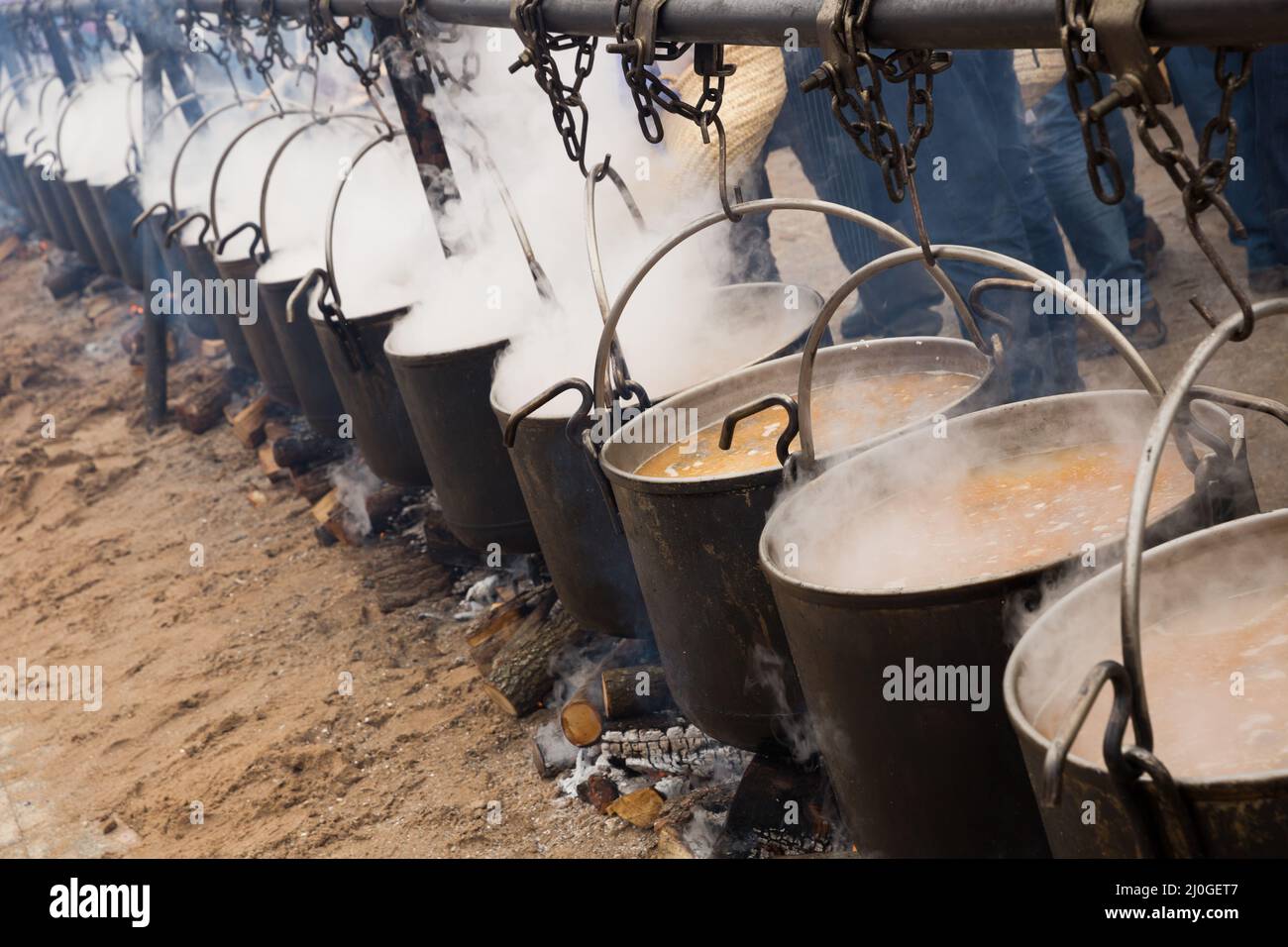 Bowlers with food on bonfire, cooking outdoor in a traditional style ...