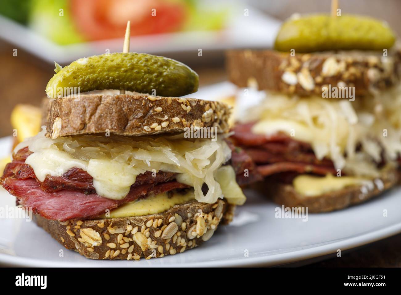 Reuben sandwich on rustic wood Stock Photo - Alamy
