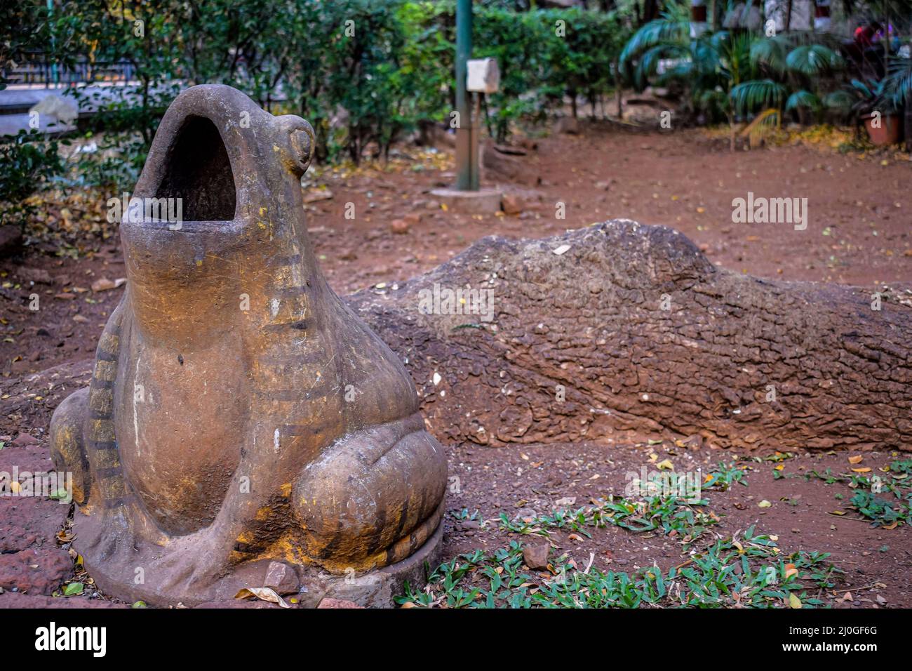 Old dirty open-mouthed frog in the public park at Kolhapur, Maharashtra ...